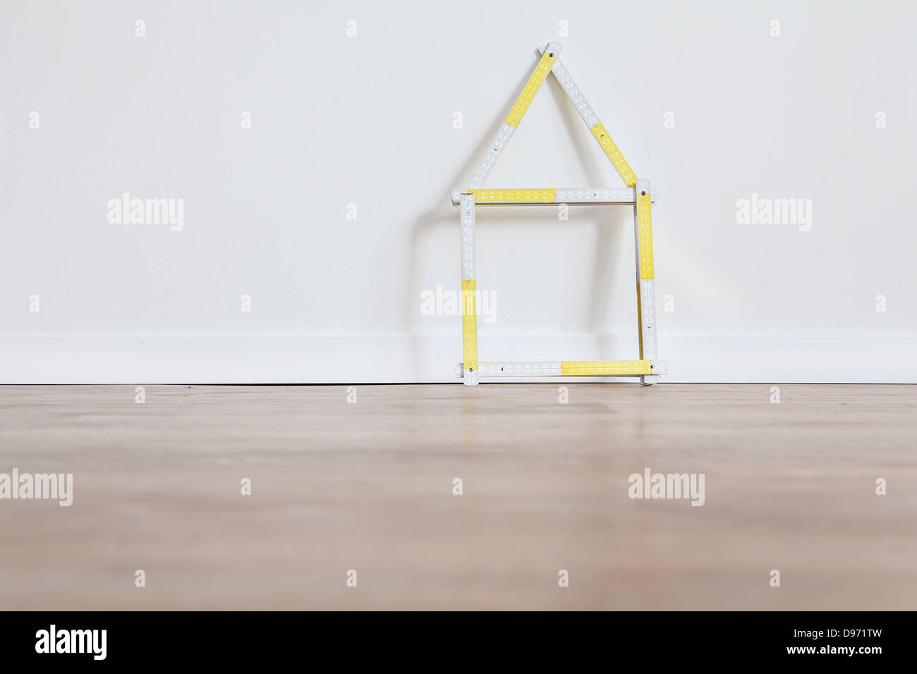 Folded ruler in house shape on wall Stock Photo - Alamy
