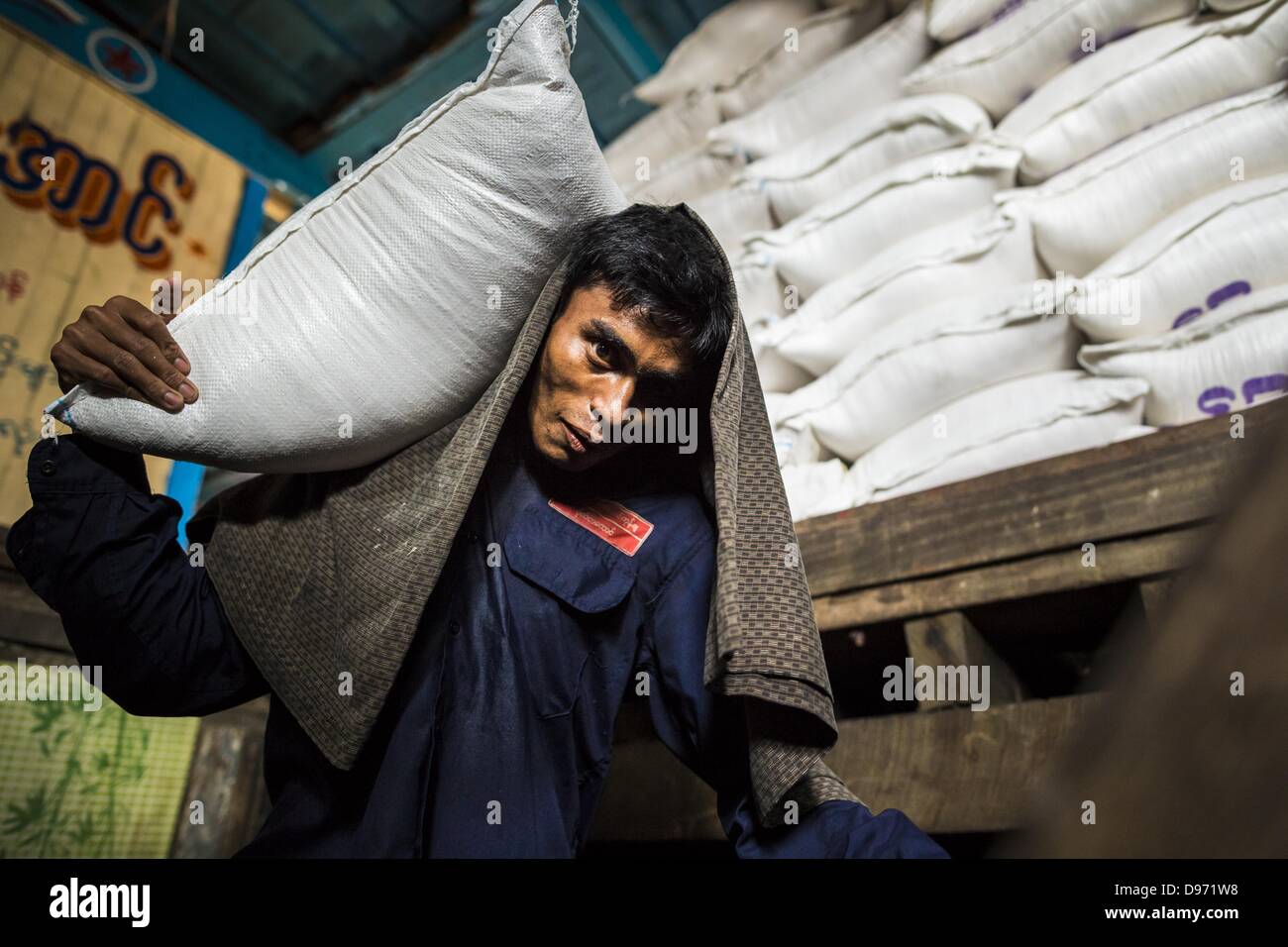 June 12, 2013 - Yangon, Union of Myanmar - Steverdores carry sacks of ...