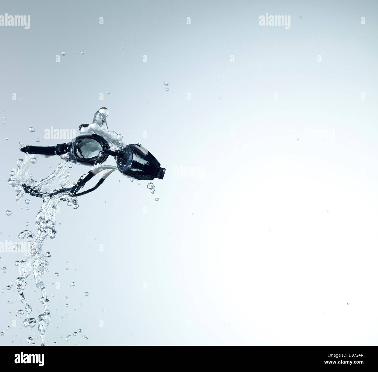 Swimming goggles with splashing water Stock Photo - Alamy