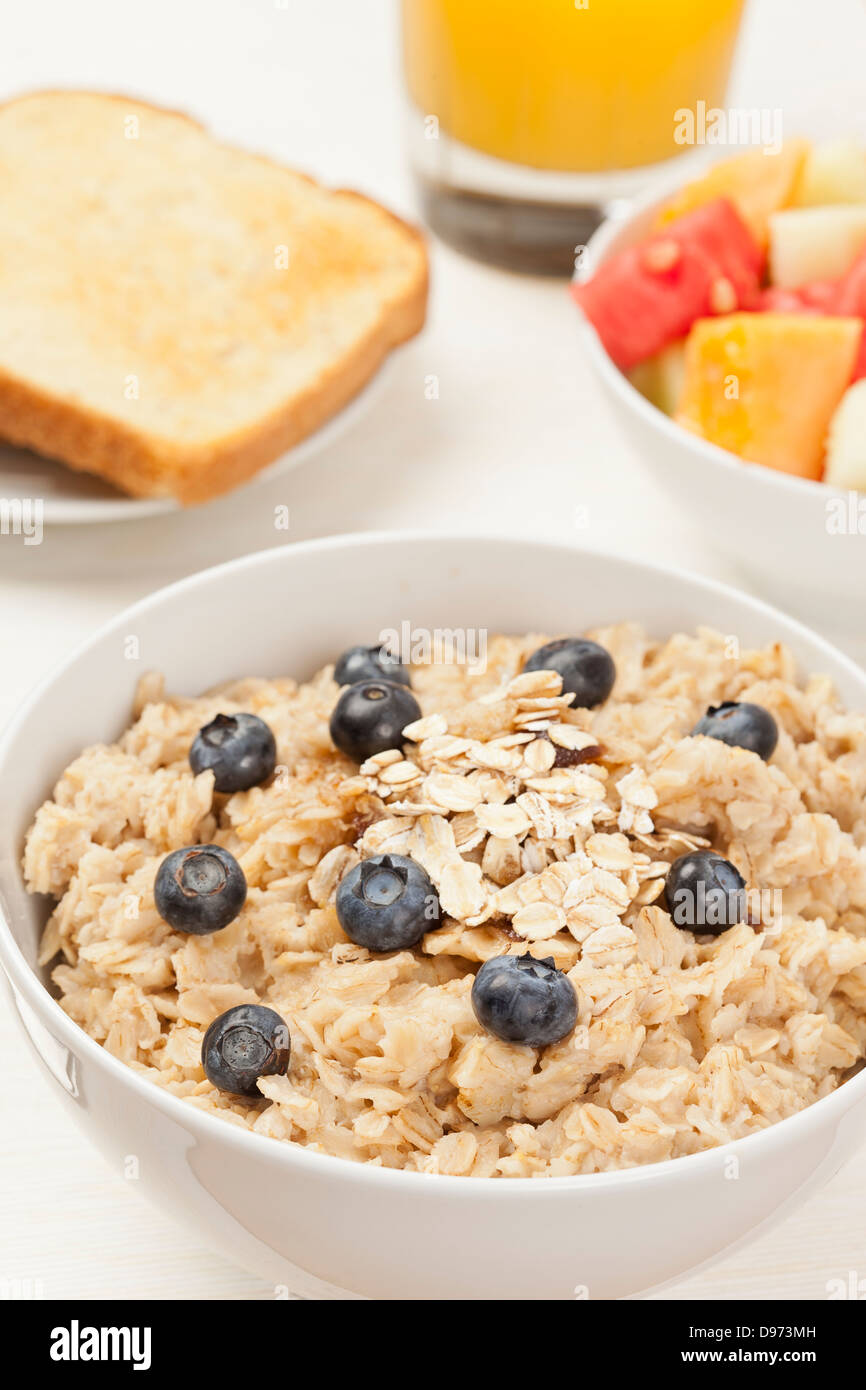Organic Cooked oatmeal with other breakfast items Stock Photo - Alamy