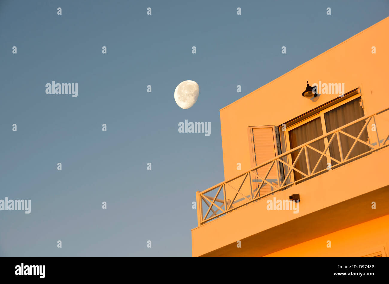 Spain, Rising moon over balcony Stock Photo - Alamy