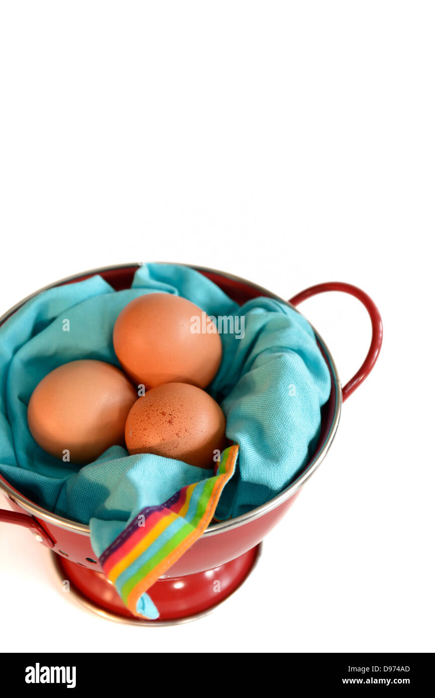 Brown eggs in colander on white background Stock Photo - Alamy