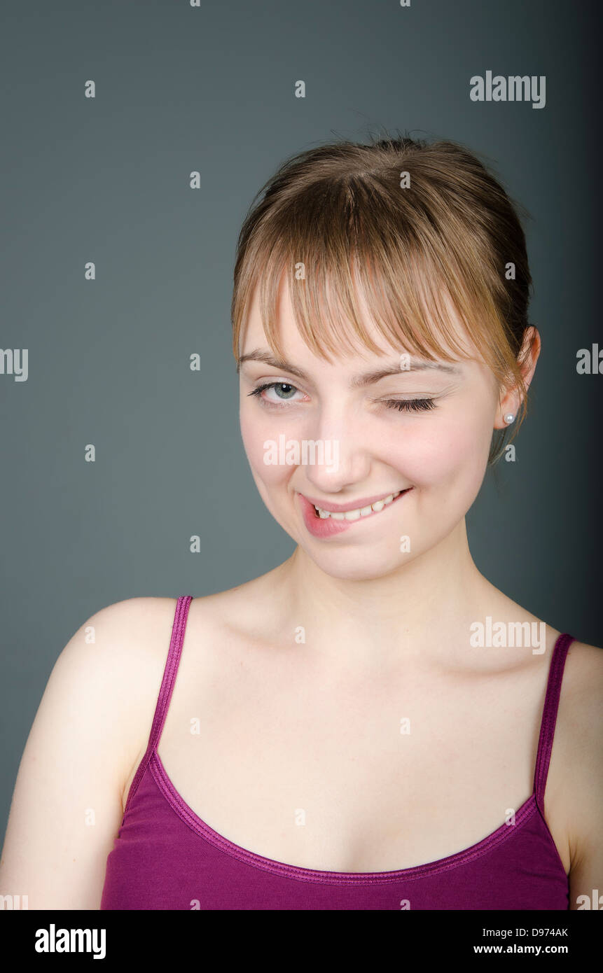 Portrait of young woman winking, close up Stock Photo - Alamy