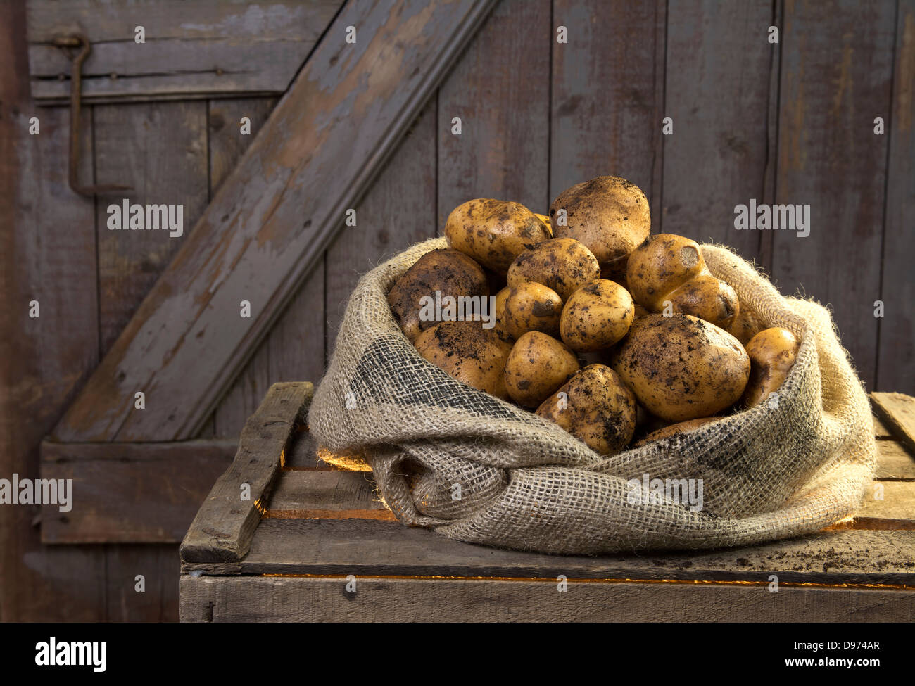 Germany, Potatoes in sack on wood Stock Photo - Alamy