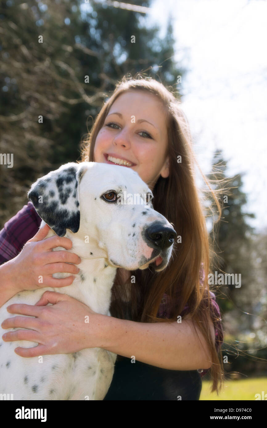 Germany, Portrait of teenage girl with dalmatian dog, smiling Stock ...
