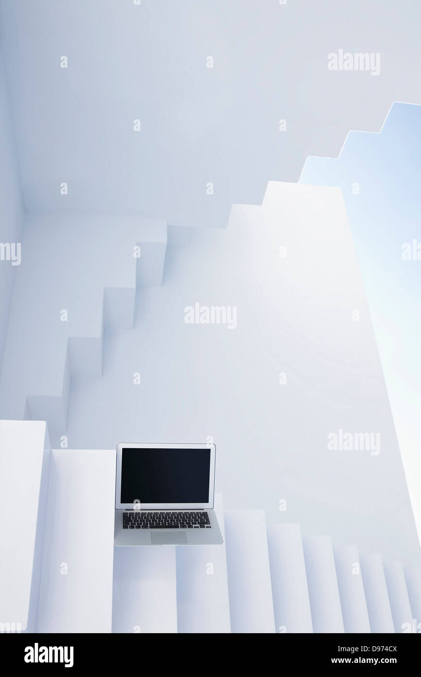 Laptop on white modern stairs Stock Photo - Alamy