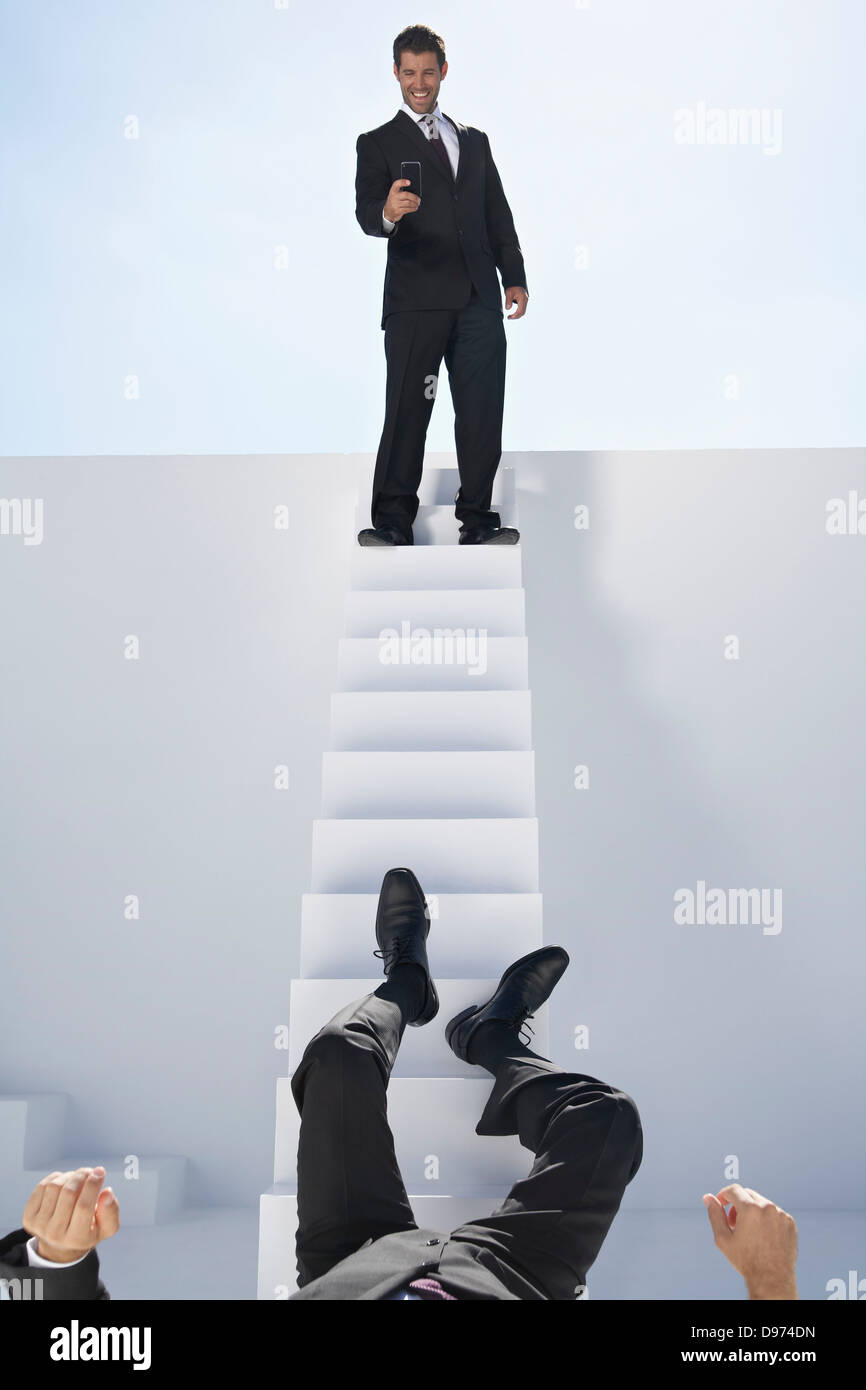 Businessman taking photograph of another man Stock Photo - Alamy