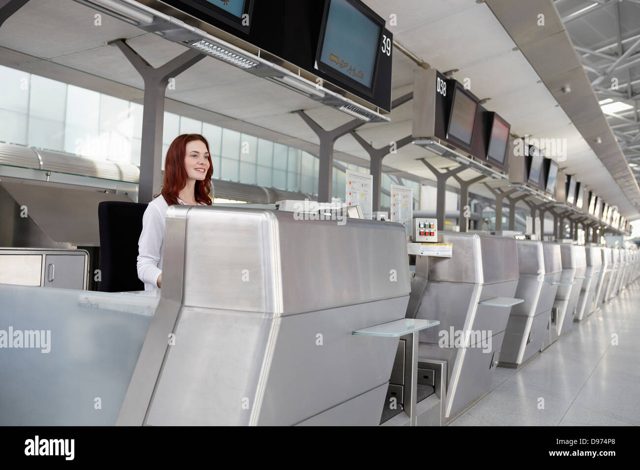Germany, Cologne, Young woman at ticket counter Stock Photo - Alamy