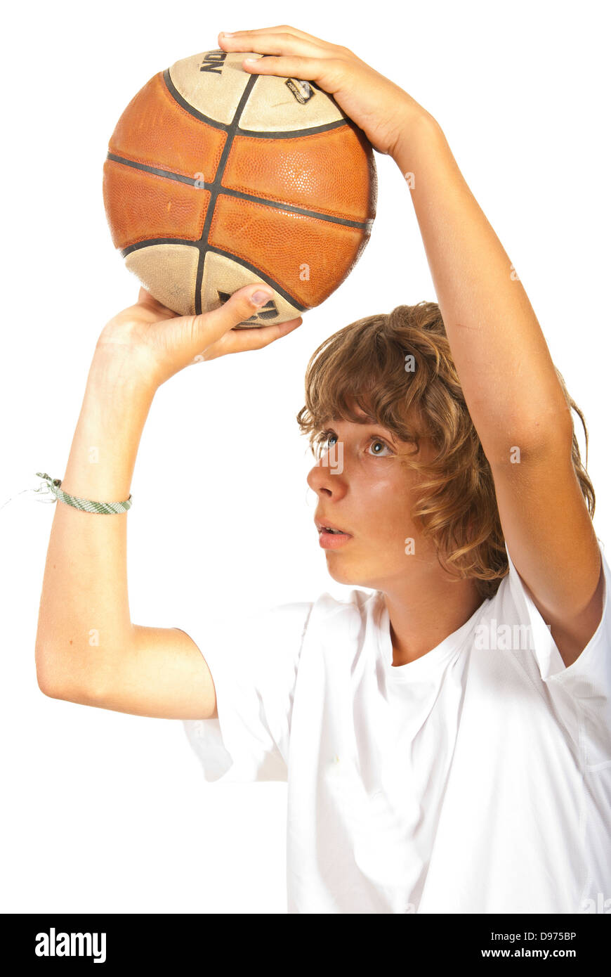 Closeup of teen boy throwing basketball isolated on white background ...