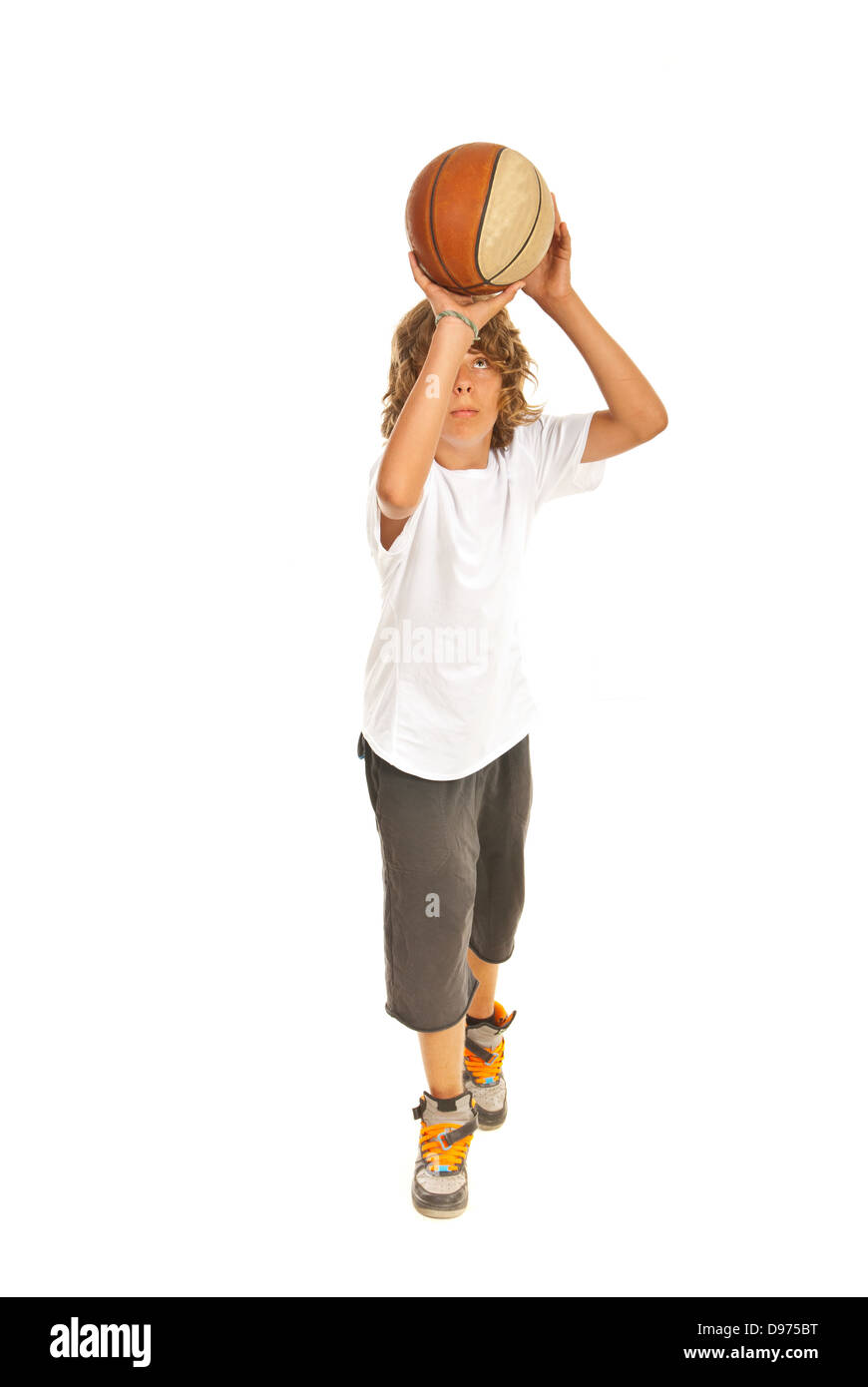 Full length of teen boy throwing basketball isolated on white ...