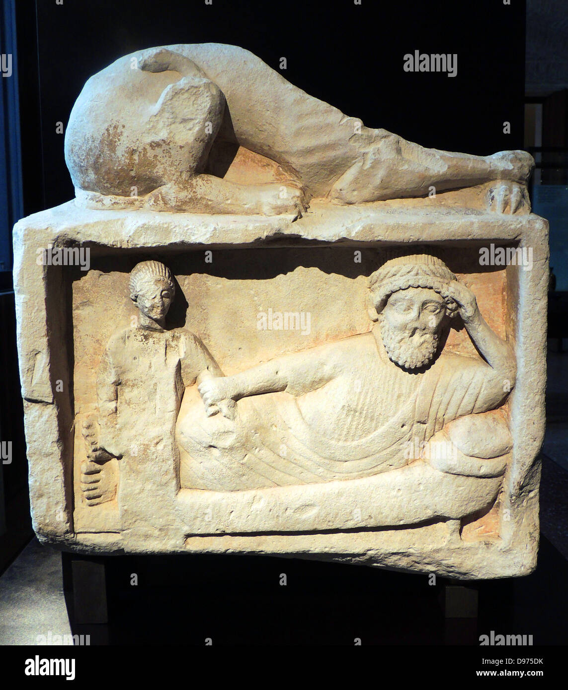 Funerary relief. The deceased rests on a Kline, an animal figure ...