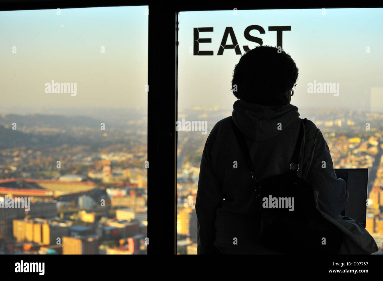 A person stands on the observation deck of the tallest building in ...
