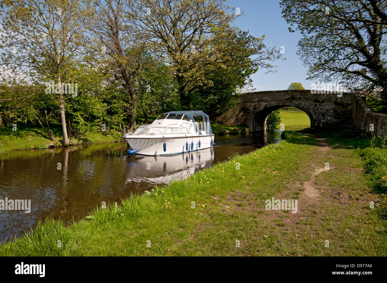 Pleasure boat boating on the inland waterway Lancaster Canal in summer ...