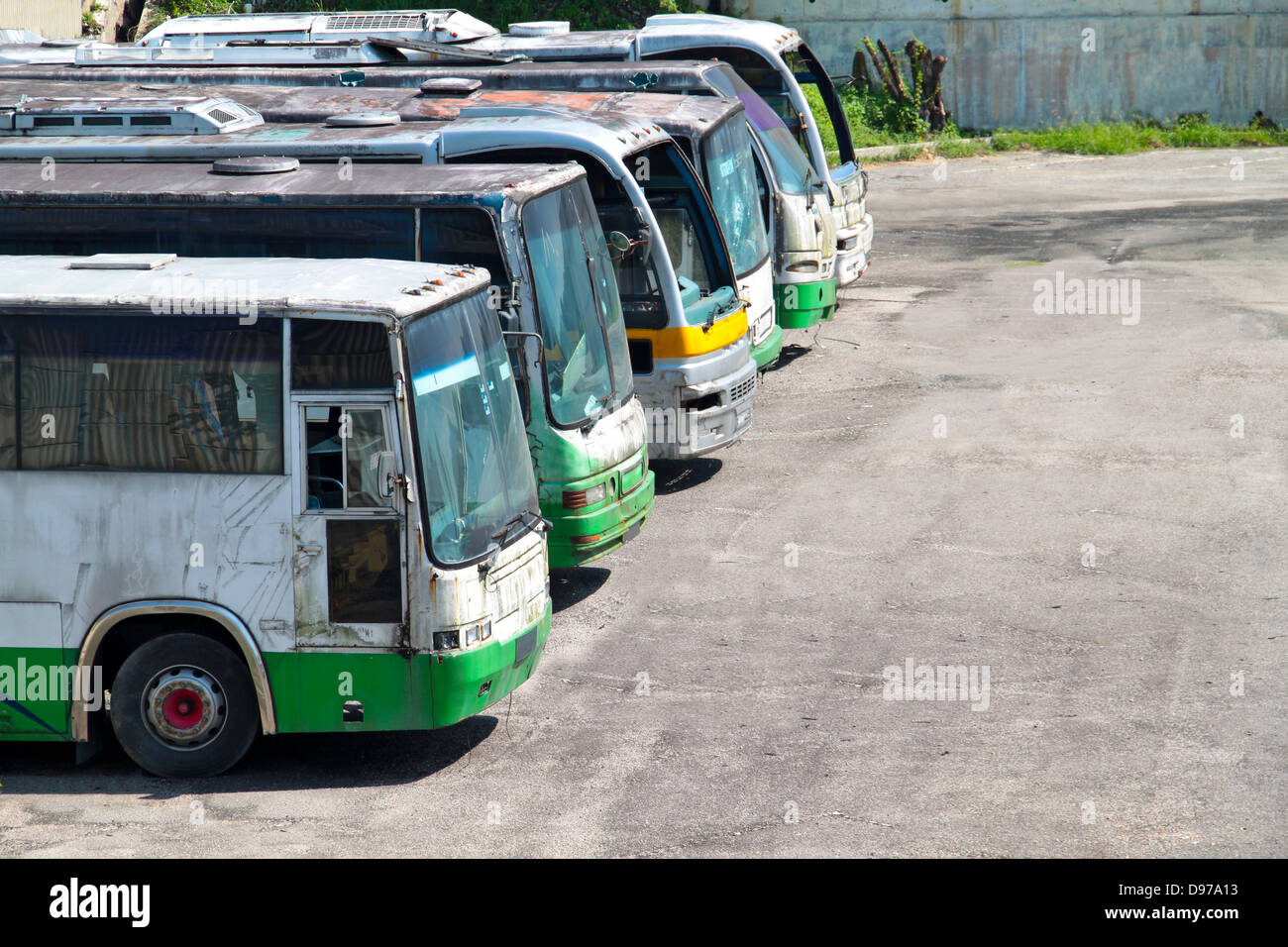 Row of breakdown buses waiting to be scraped. Concept of open-air old ...