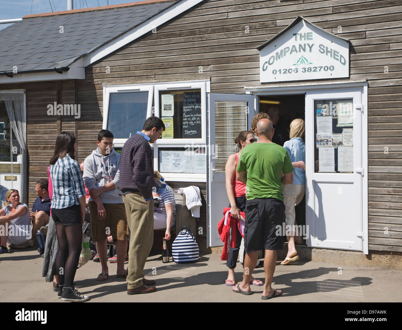 Queue of people outside the Company Shed fish restaurant, West Mersea ...