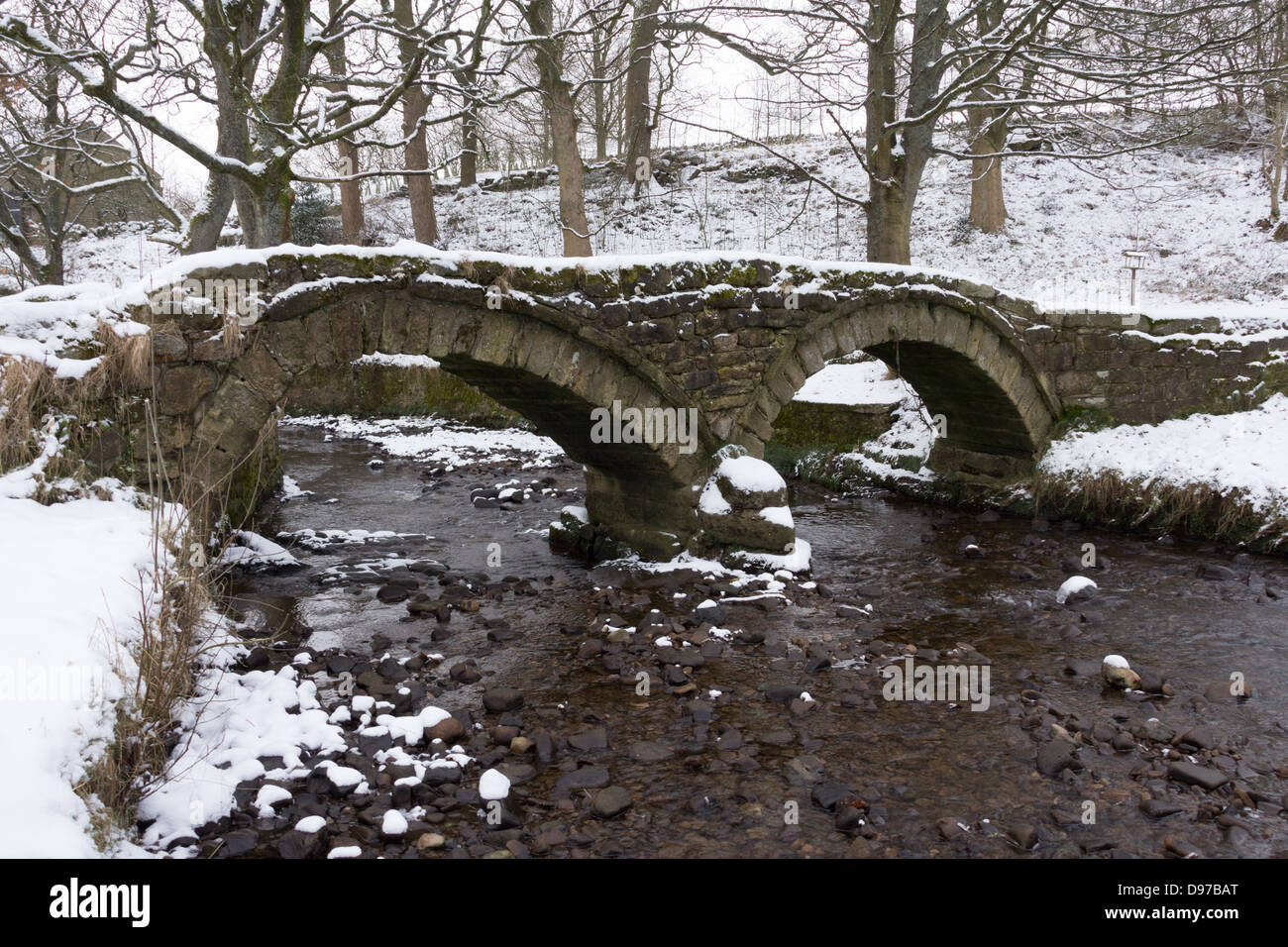 Snow covered bridge over stream Stock Photo - Alamy