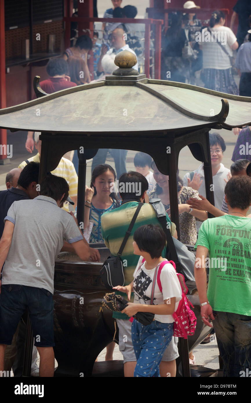 Visitors offering incense before Senso-ji Temple Main Hall Stock Photo ...