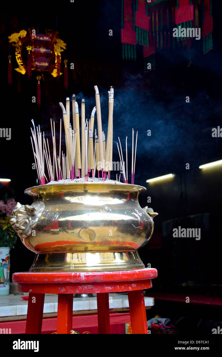 Joss stick burning in incense furnace at a chinese temple. Concept of ...