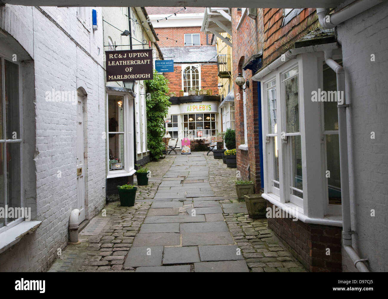Shops in cobbled street of old alleyway, Marlborough, Wiltshire ...