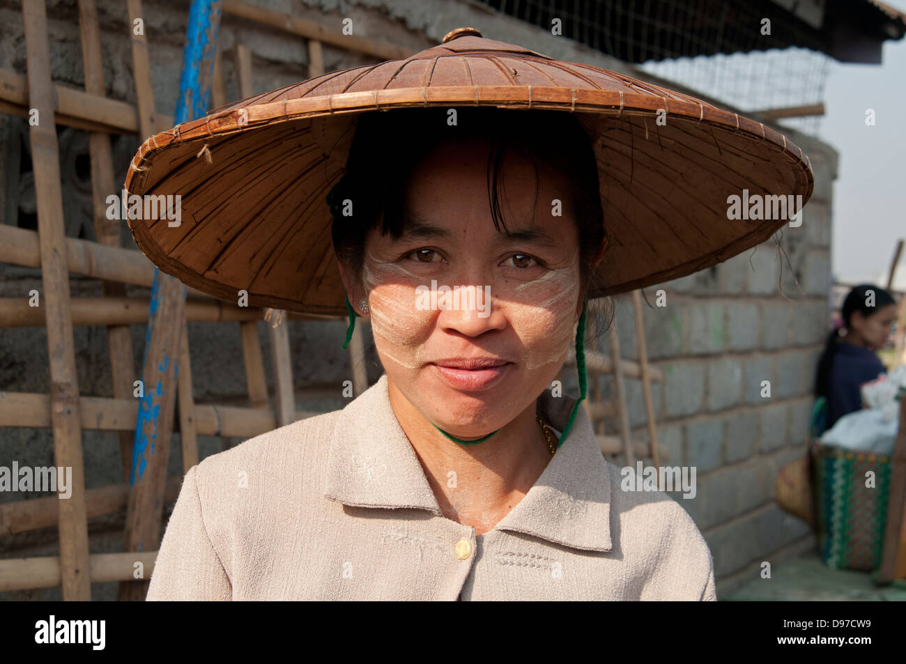 Burmese woman wearing a bamboo conical Shan states hat smiling at the ...