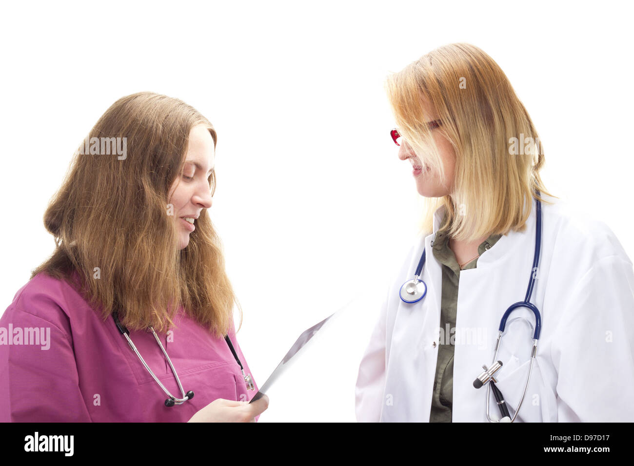 Two female doctors discussing about a patients health problems Stock ...