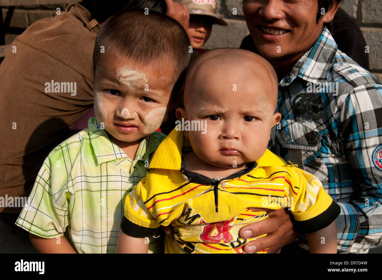 two Burmese baby boys with thanakha bark paste on their face Inle lake ...