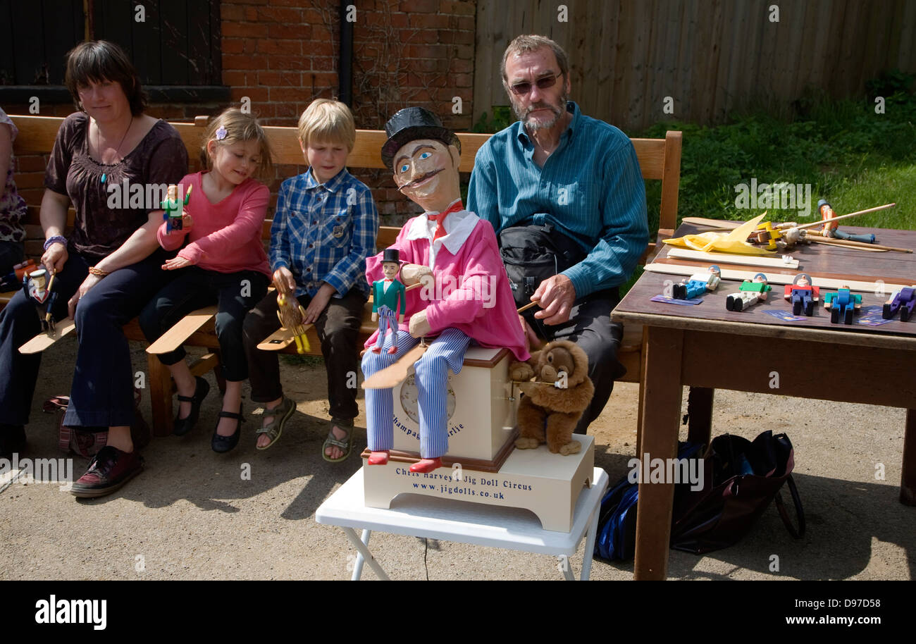 Man operating a traditional wooden jig doll dancer during a country ...