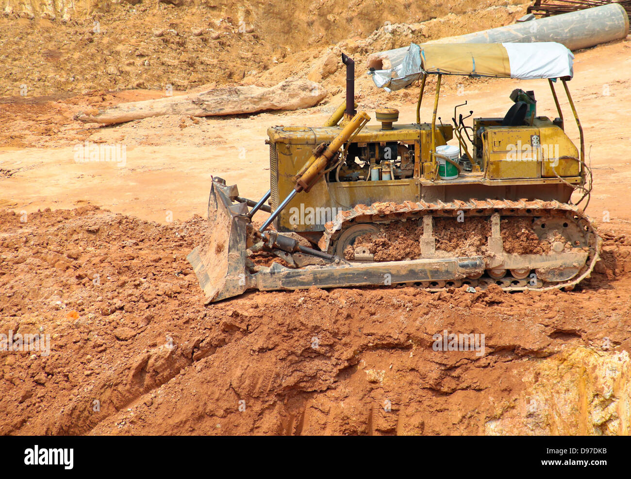 Muddy bulldozer at construction site Stock Photo - Alamy