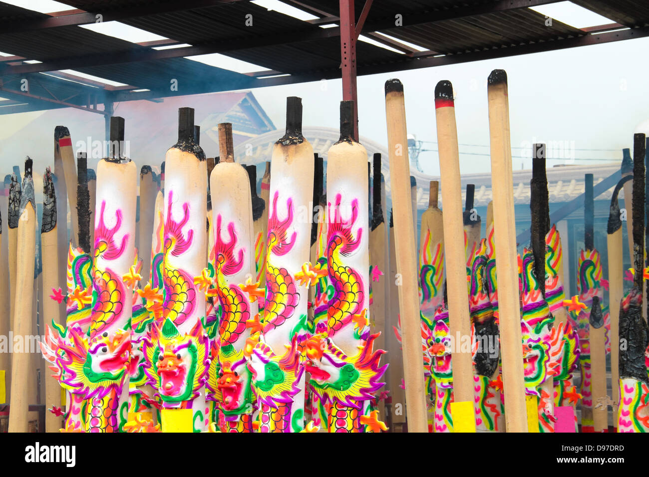 Rows of large joss stick burning Stock Photo - Alamy