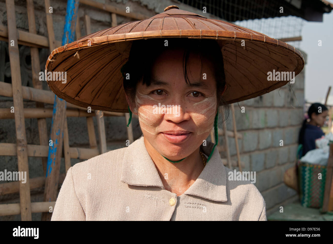 Burmese woman wearing a bamboo conical Shan states hat smiling at the ...