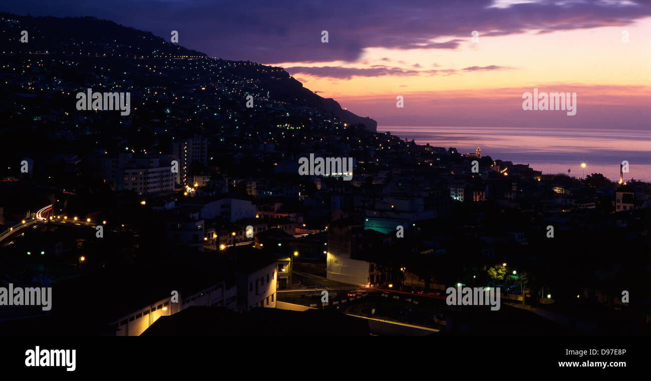 A beautiful sunrise across the sea in the background, with a hillside ...