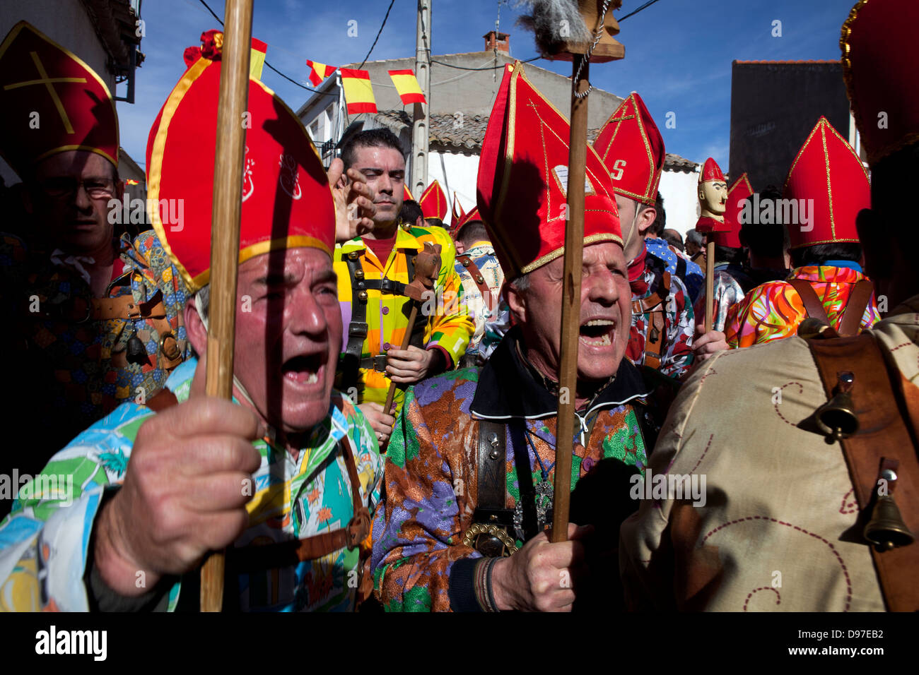 The Endiablada. A group of "devils" cross the streets of town dancing ...