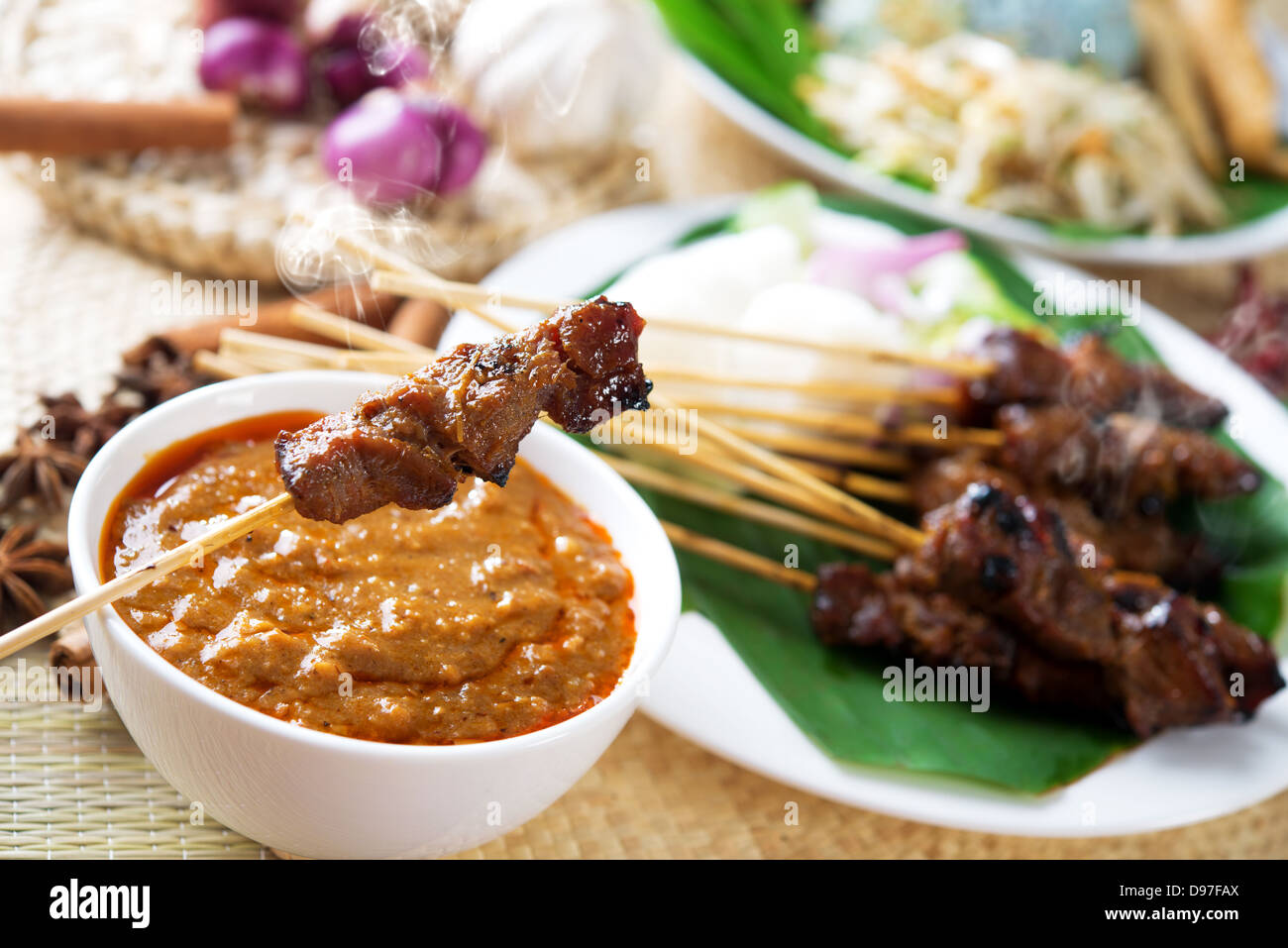 Satay or sate, skewered and grilled meat, served with peanut sauce ...