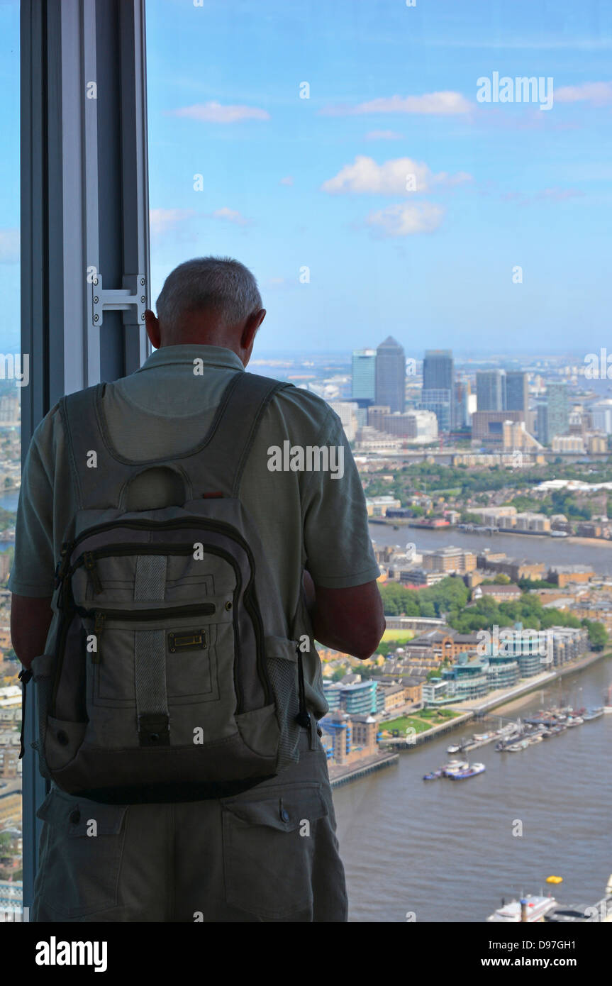 Back view of visitor to Shard landmark skyscraper building admiring ...