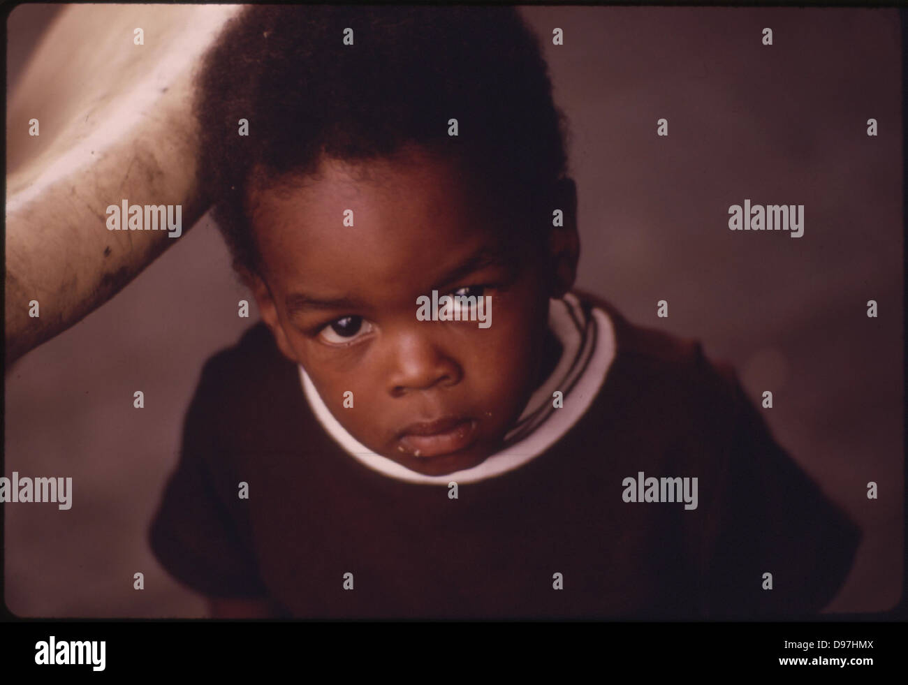 A Black Child On The Rear Porch Of A House In A Very Low Income Area On ...