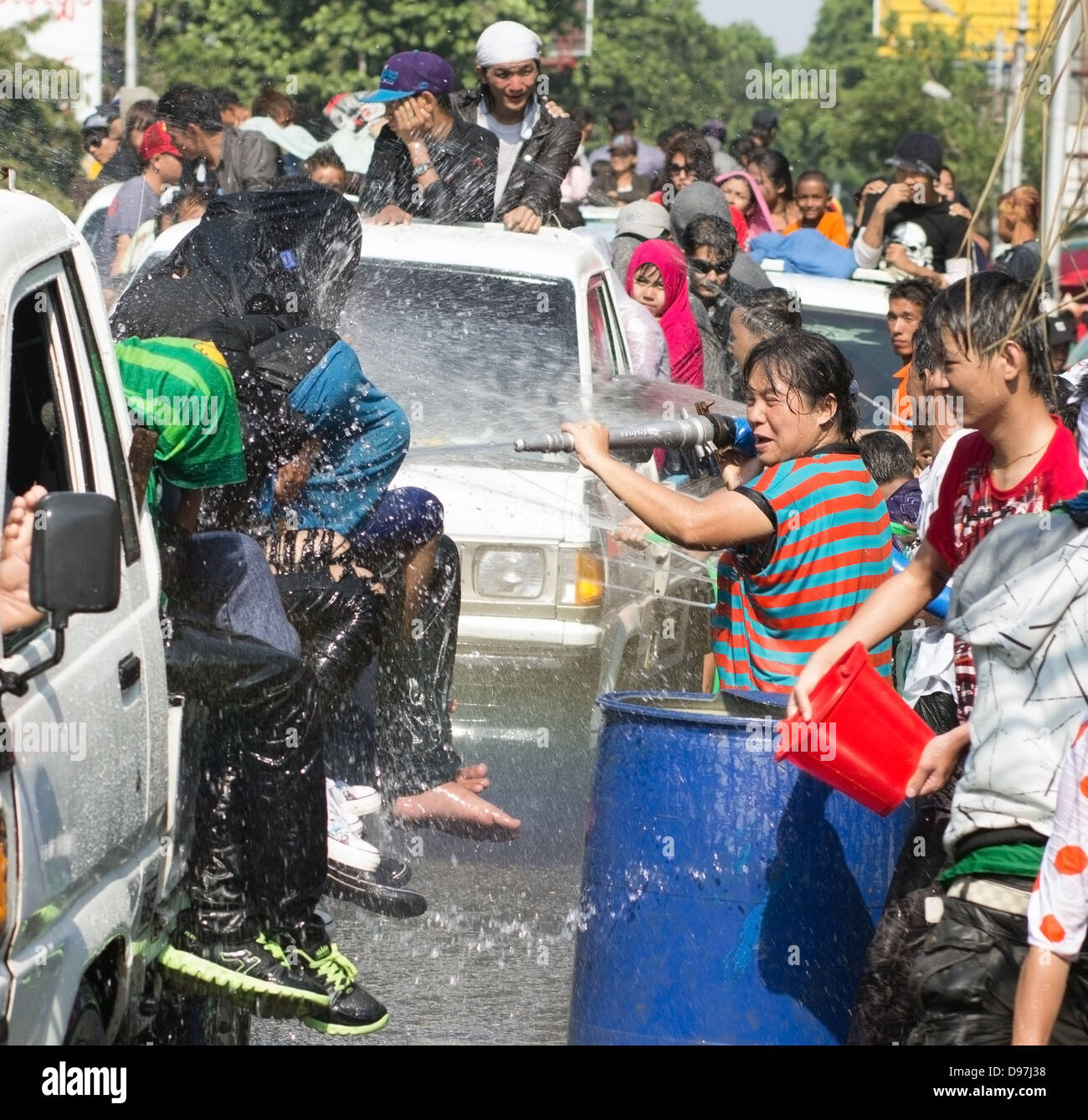 cheerful people on street, Water festival Stock Photo - Alamy
