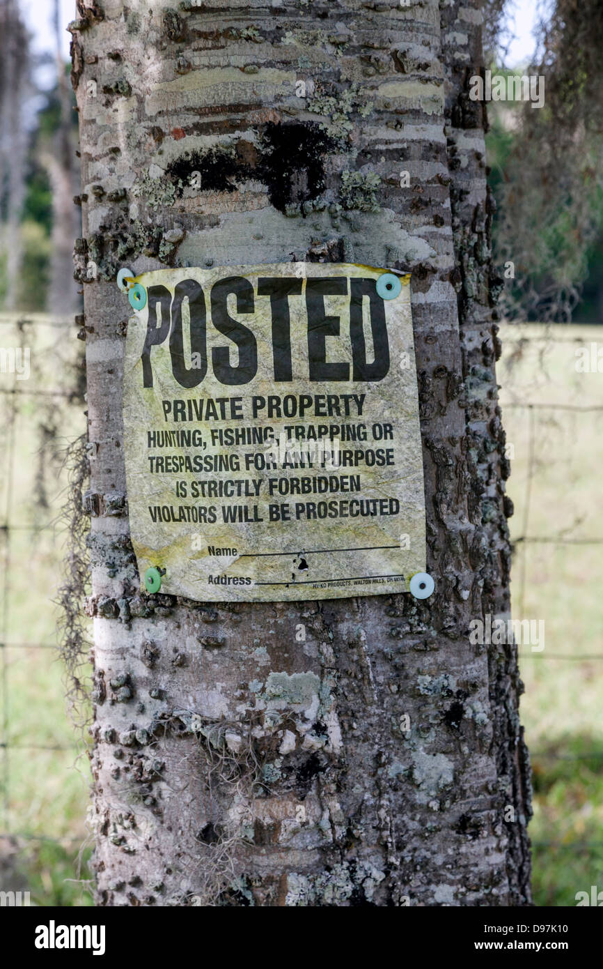 Posted private property sign nailed to a tree Stock Photo - Alamy