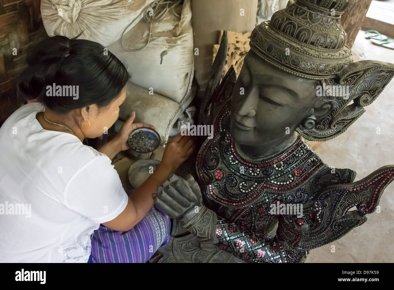 woman working on the statue Stock Photo - Alamy
