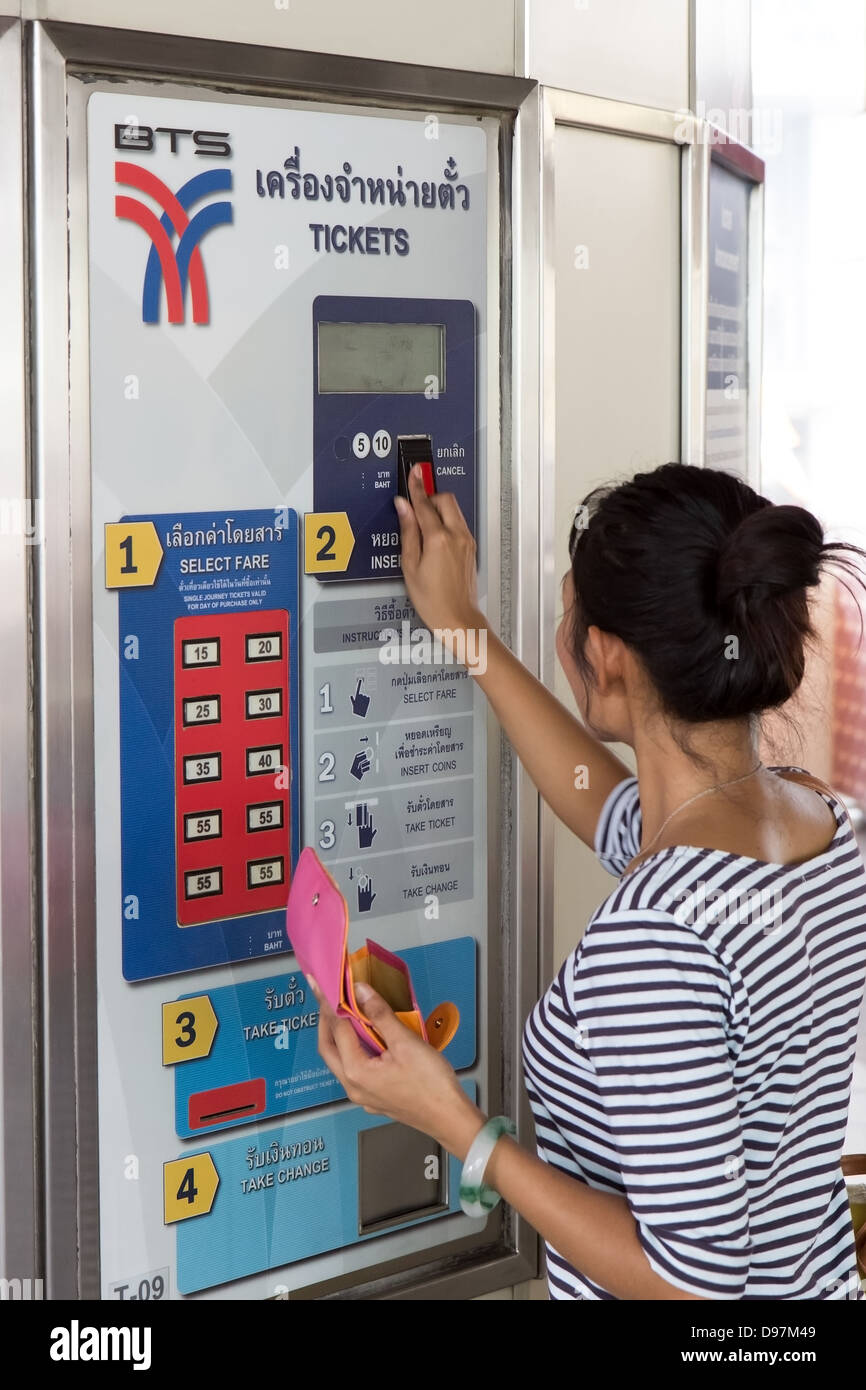 Woman buys a ticket Stock Photo - Alamy