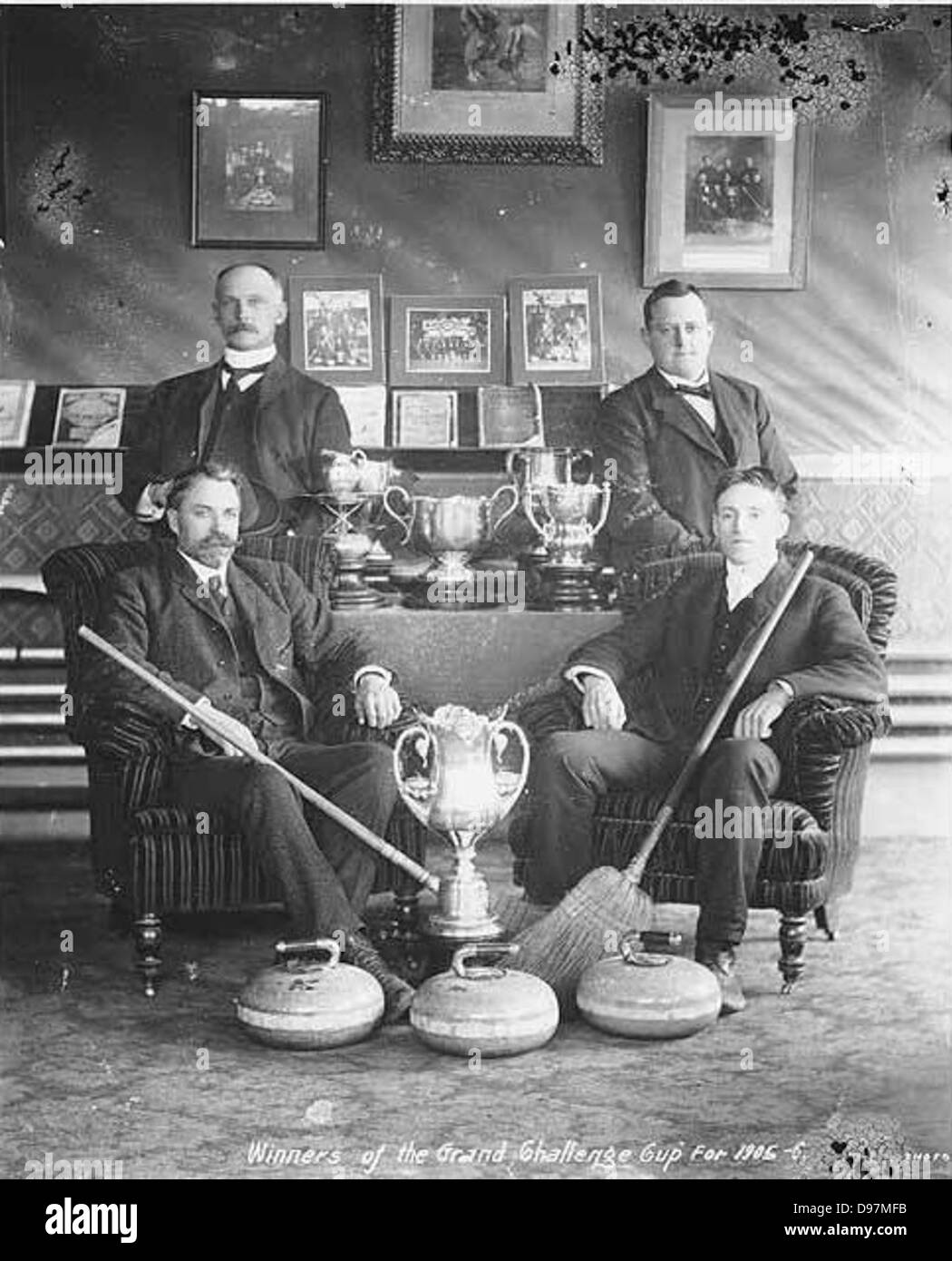 Curling team sitting around trophies, Dawson, Yukon Territory Stock ...