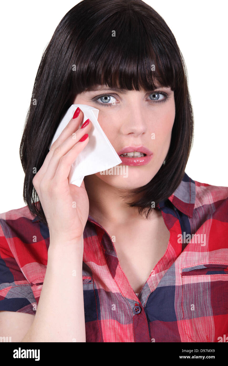 Woman wiping away a tear Stock Photo - Alamy