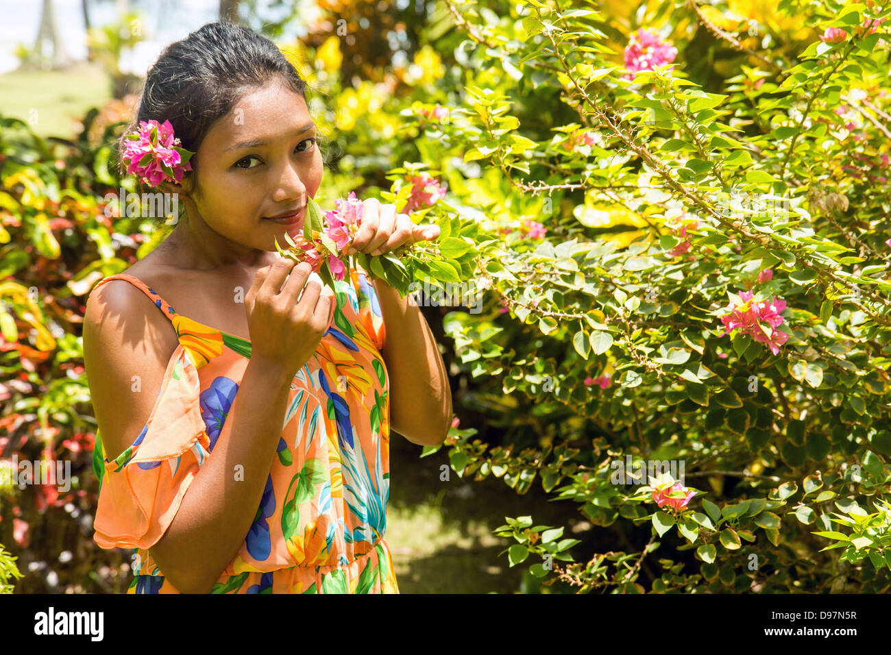 woman sniffs a flower Stock Photo - Alamy