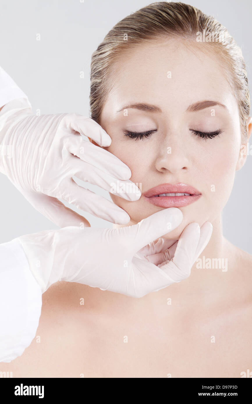 doctor checking woman's lips before cosmetic surgery Stock Photo - Alamy