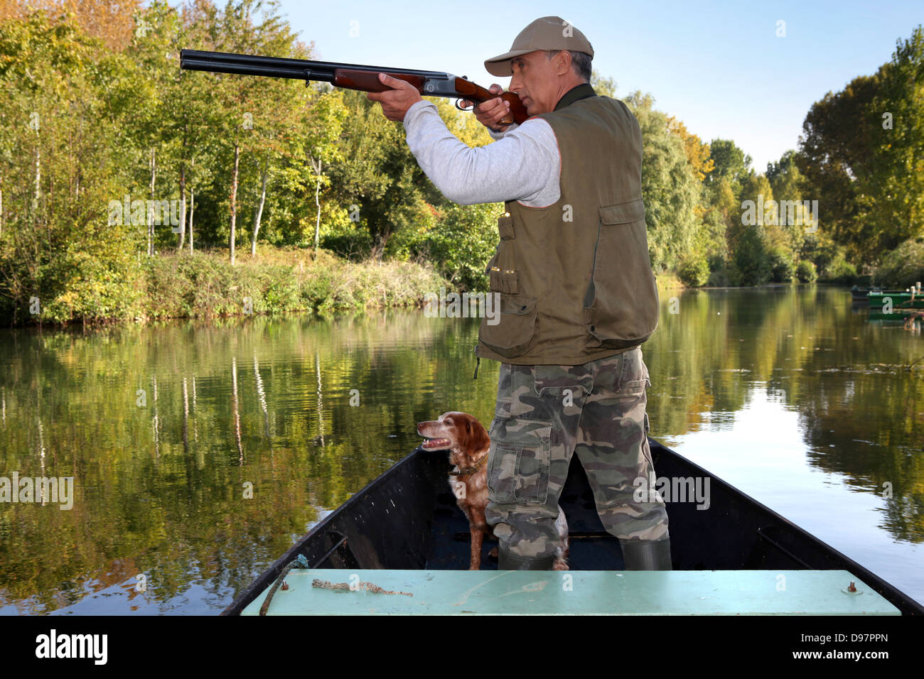hunter in boat Stock Photo - Alamy