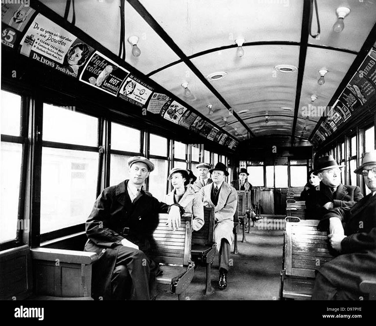 This image shows the interior of a streetcar in Seattle with passengers ...