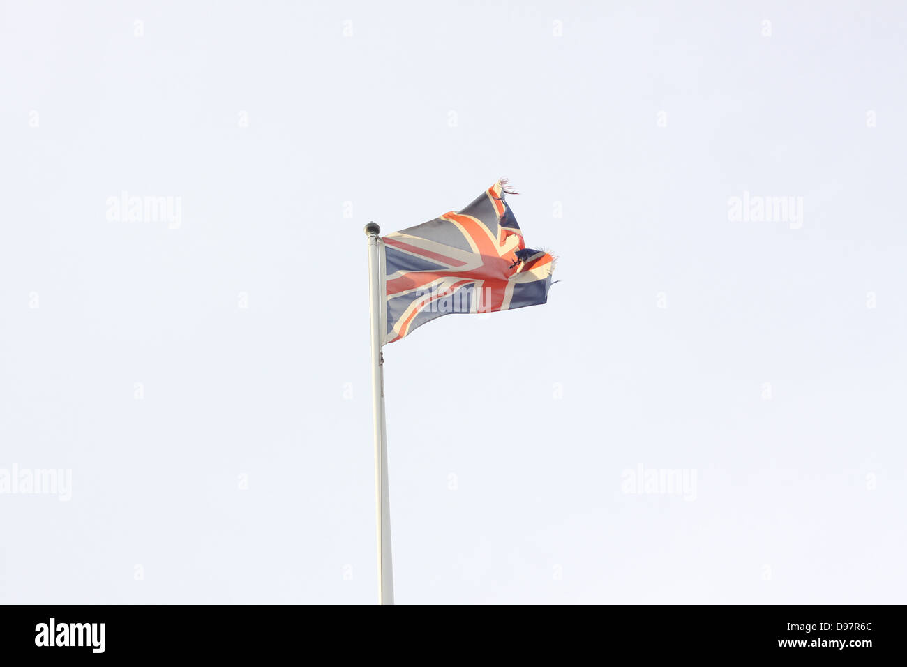 A damaged Union Flag fluttering in the wind Stock Photo - Alamy