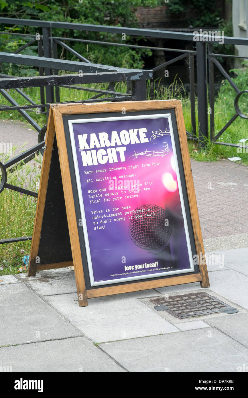 A frame notice board on pavement advertising a Karaoke night singing ...