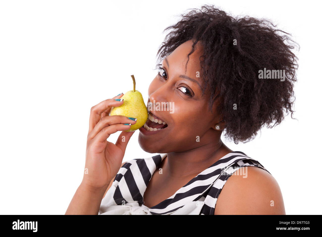 Overweight young black woman eating an pear, isolated on white ...