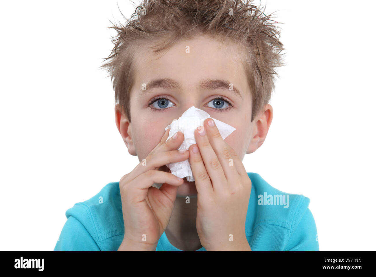 Young boy blowing his nose Stock Photo - Alamy