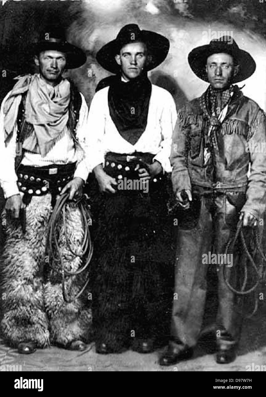 Studio portrait of three men dressed as cowboys Stock Photo - Alamy